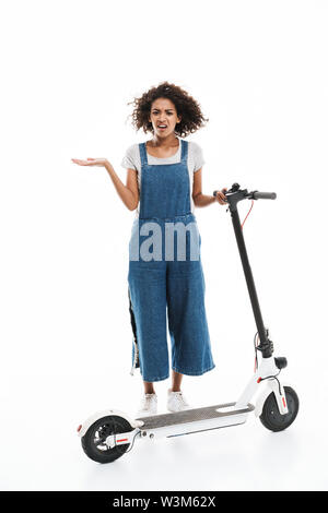 Image of nice puzzled woman with curly red hair holding cellphone and ...