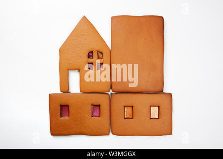 The parts of a gingerbread house for Christmas on a red and white ...
