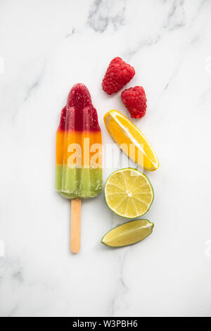 Summer fruit ice lollies made with orange lime and raspberries Stock ...