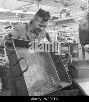 1950s, historical, male steel worker with protective visor working at a ...