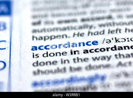 The word or phrase Accordance in a dictionary highlighted with marker ...