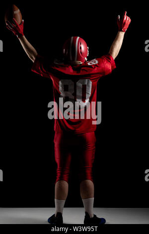 American football player cheering with arms up Stock Photo - Alamy