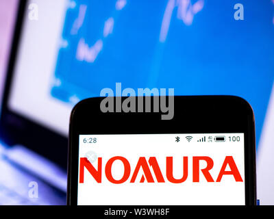 In this photo illustration a Nomura Holdings, Inc logo seen displayed ...