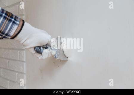 Putty the wall gypsum putty with spatulas Stock Photo - Alamy