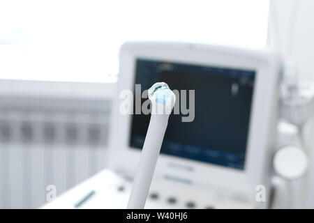 the gynecologist holds the sensor for vaginal examination with an ...