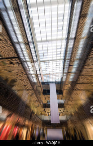 Defocused shopping mall interior with bright lights and modern ...