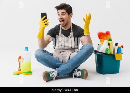 Image of a happy young houseman househusband isolated over white wall ...