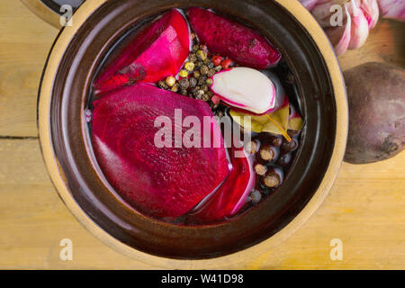 Dish with pickled beets. Rural wooden table. Preparation of borscht ...
