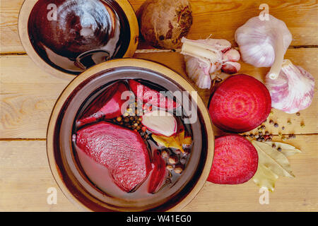 Dish with pickled beets. Rural wooden table. Preparation of borscht ...