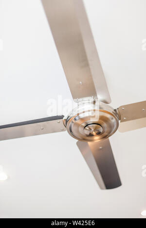 Stylish metallic four wing ceiling fan exuding a royal look Stock Photo ...