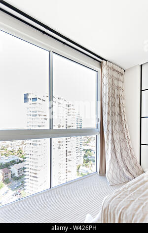 Open door with a view of skyscrapers and modern buildings with a blue ...