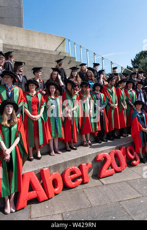 Graduation ceremony doctoral graduates wearing cap and gown in line ...