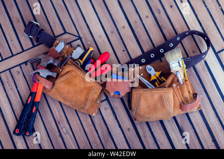 Leather tool belt construction tooling on wooden board vertical image ...