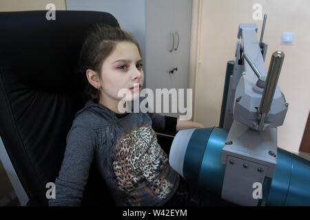 A girl living near the Chernobyl Exclusion Zone is checked with the ...