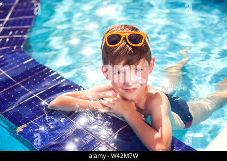 boy sunbathing in the pool Stock Photo - Alamy