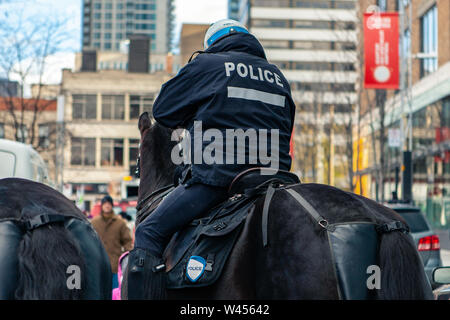 Rear view of Police Officer Watching Over Crowds in Trafalgar Square ...
