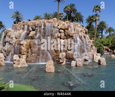 Waterfalls in a beautifully-landscaped garden with palm trees Stock ...