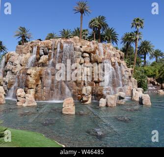Waterfalls in a beautifully-landscaped garden with palm trees Stock ...
