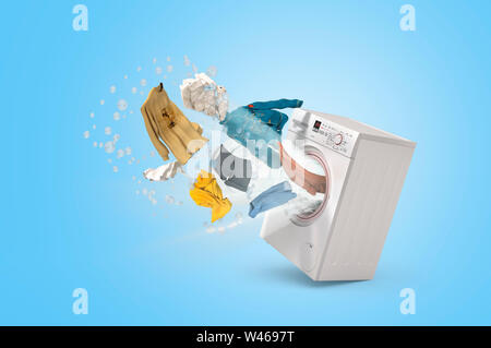 Washing machine and flying clothes on blue background Stock Photo - Alamy