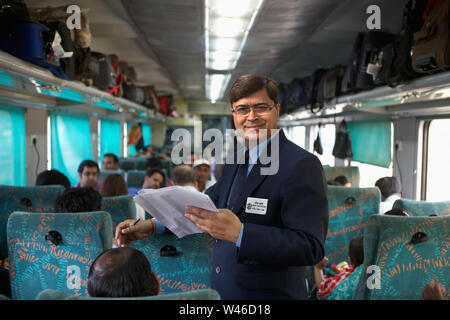Ticket collector checking tickets in a train Stock Photo - Alamy