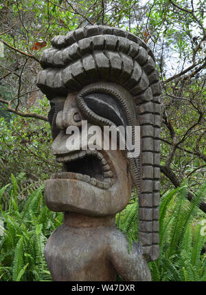 A carved wooden statue of the Hawaiian god Ku centers the banyan canyon ...