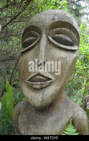 A carved wooden statue of the Hawaiian god Ku centers the banyan canyon ...