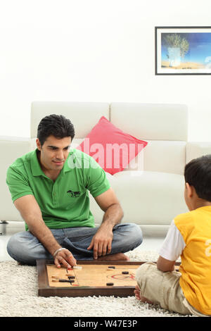 1 child boy playing Carom Board Stock Photo - Alamy