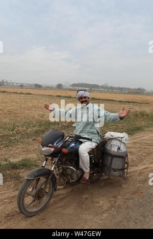 Milkman delivering milk on a motorcycle Stock Photo - Alamy