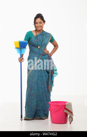 Black woman, broom and cleaning with a smile and mockup in a home ...