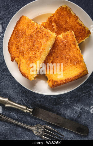 Corn Bread Squares Slices in White Plate on Dark Blue Rustic Background ...