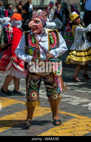 A man dressed in a costume performs during the mask festival in Porto ...