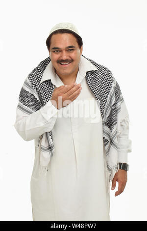 Portrait of a Muslim man greeting with adab Stock Photo - Alamy