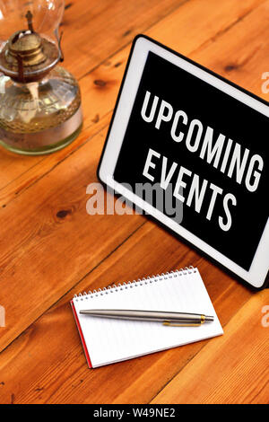 Writing equipments placed next to gadget plus a classic vintage lantern ...