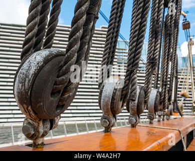Deck, ropes, rigging and wooden pulleys / blocks on board of sailing ...