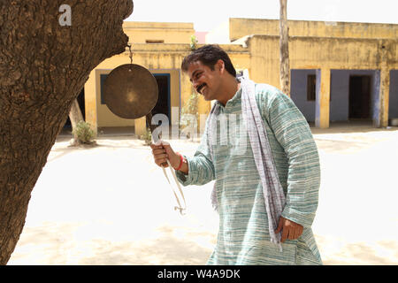 Man ringing bell in school Stock Photo - Alamy