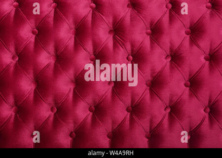 Maroon red velvet capitone textile background, retro Chesterfield style ...