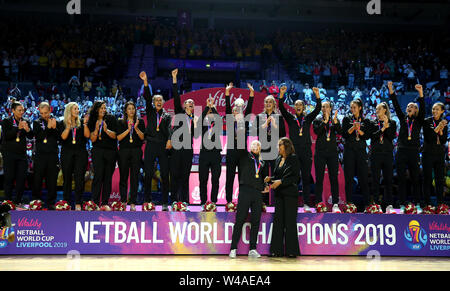 New Zealand's Laura Langman (centre) lifts the trophy with her team ...