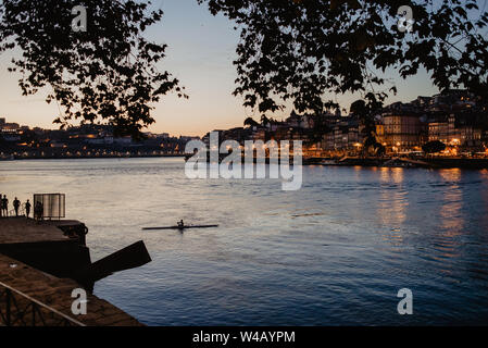 Reflection of the sun at river Douro and city during Sunset, seen from ...