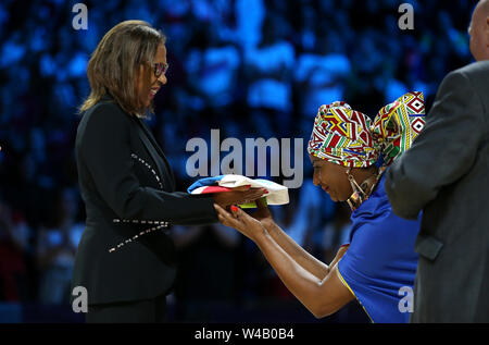 International Netball Federation President Molly Rhone hands the flag ...