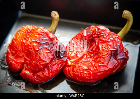 Roasted red peppers in a pan Stock Photo - Alamy
