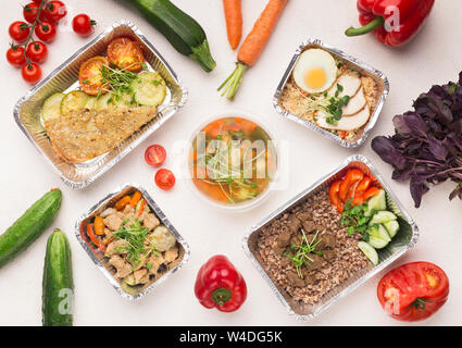 Containers with delicious food for delivery on grunge background with ...