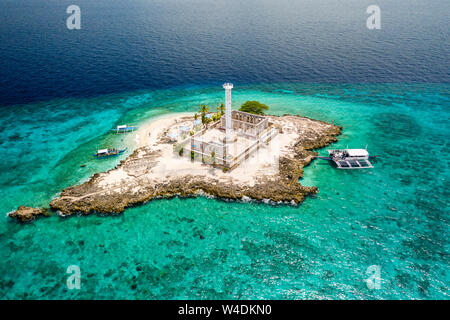 Aerial view of a huge coral reef table forming a fringing reef around a ...