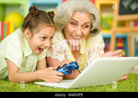 granny with her granddaughter playing computer game Stock Photo - Alamy