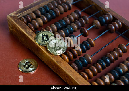 Bitcoins and classic abacus and symbol of new and old financial tool ...