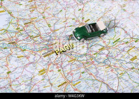 Wishing trip to Paris by car with road map Stock Photo - Alamy