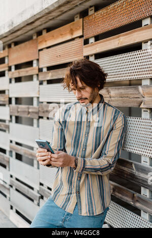 Adult man in striped t-shirt screaming and rubbing temples because of ...
