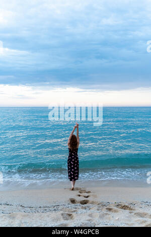 back view of young woman in sunglasses with retro bicycle on street ...