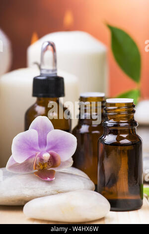 Essential oil, spa stones and candles on dark background Stock Photo ...