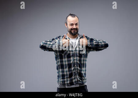 Happy gleeful man giving a double thumbs up Stock Photo - Alamy