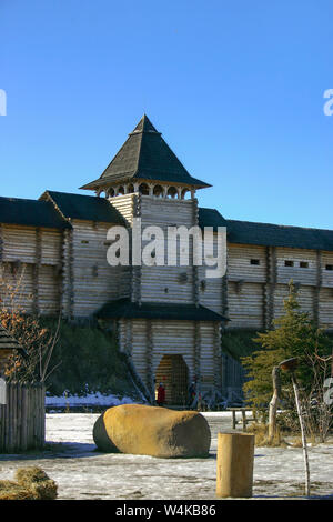 A powerful ancient wooden fortress with a central tower and a gate ...